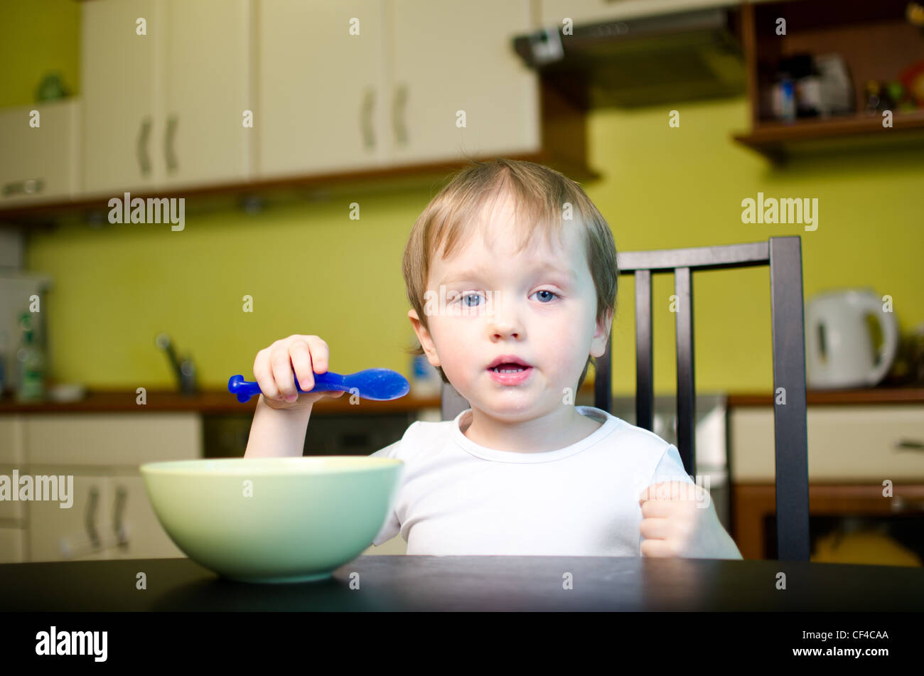 Little child eating breakfast Stock Photo - Alamy