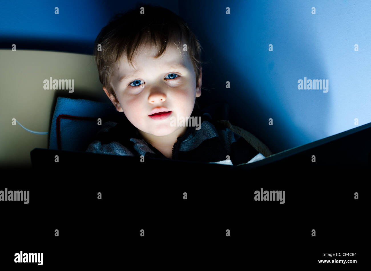 Child during reading book in his room at night Stock Photo - Alamy