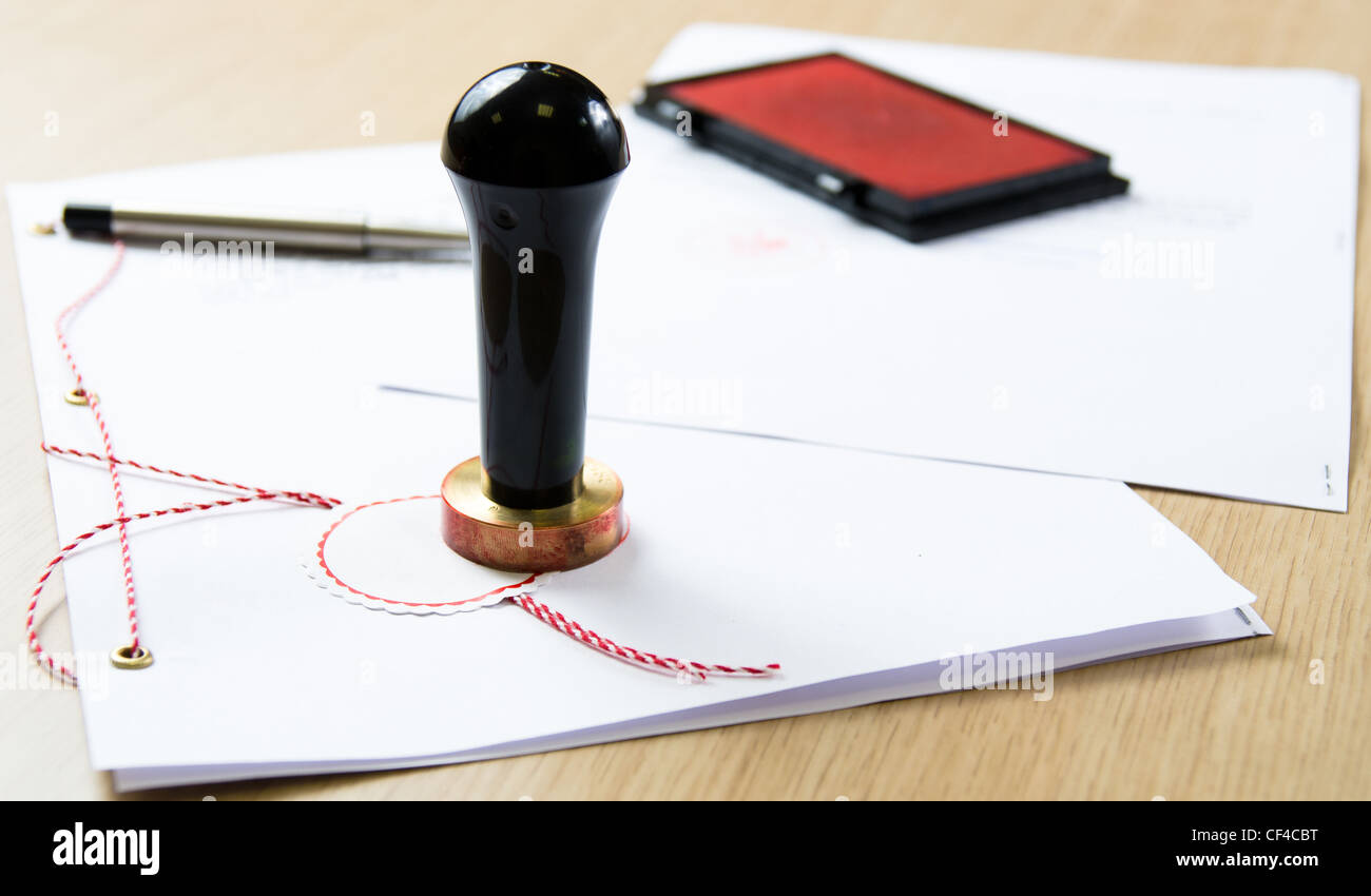 Stamp that is used by a notary public and signed document Stock Photo ...