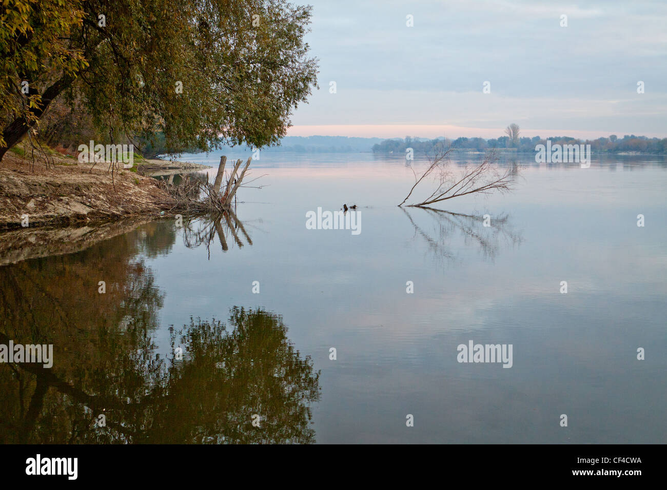 Sun rising over a river Stock Photo - Alamy