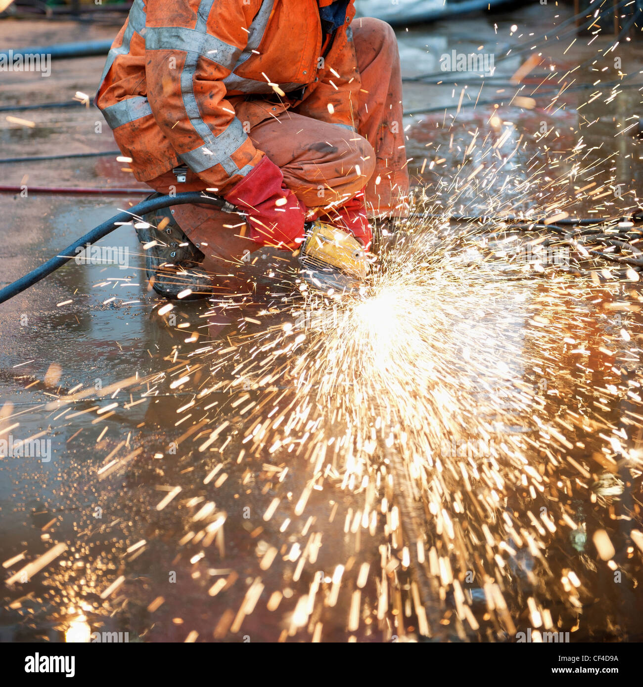 Sparks flying off a grinding machine towards the camera, smoothing the ...