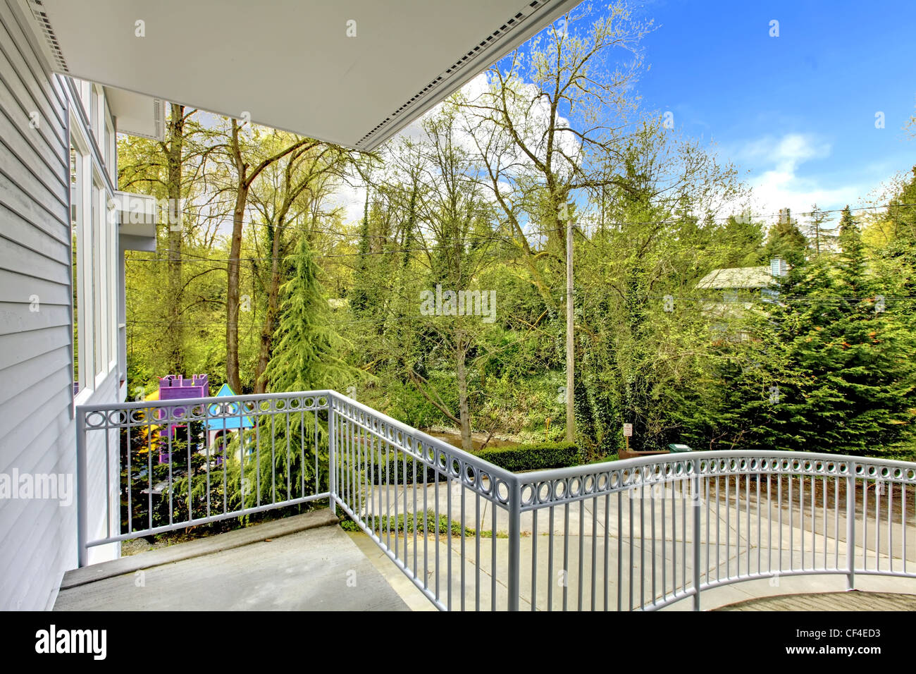 House with balcony railing and view of the driveway Stock Photo - Alamy