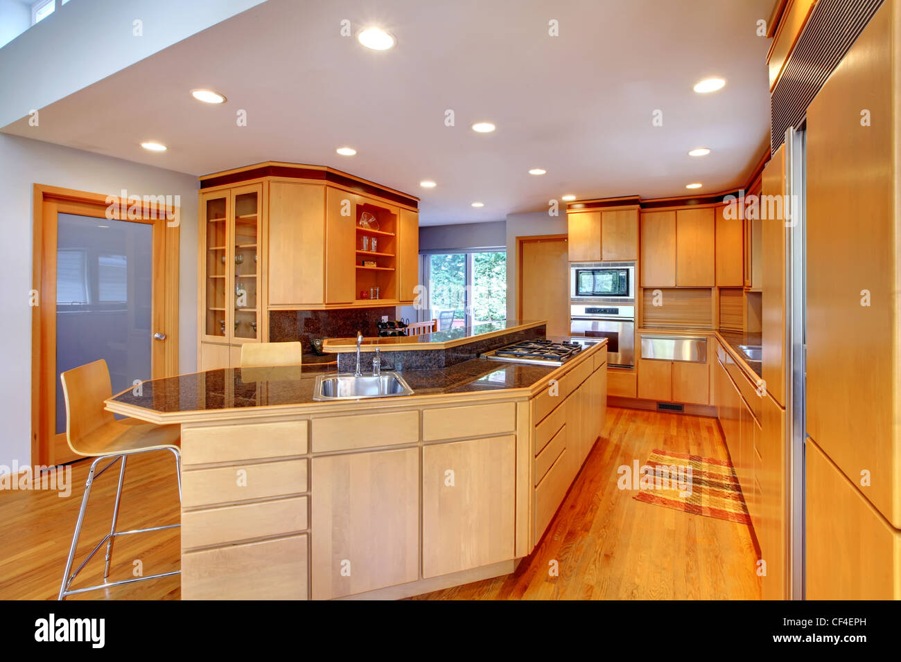 Large luxury modern wood kitchen with granite counter tops and yellow ...