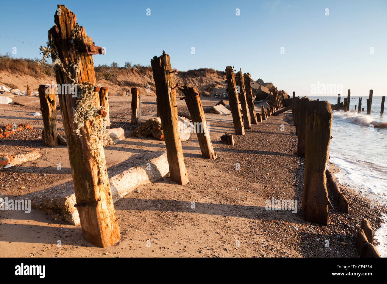 Worn posts placed in the sand at Spurn Point in an attempt to defend ...