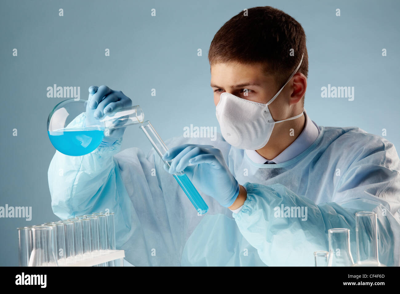 Chemist being ready to pour one substance into another in terms of ...