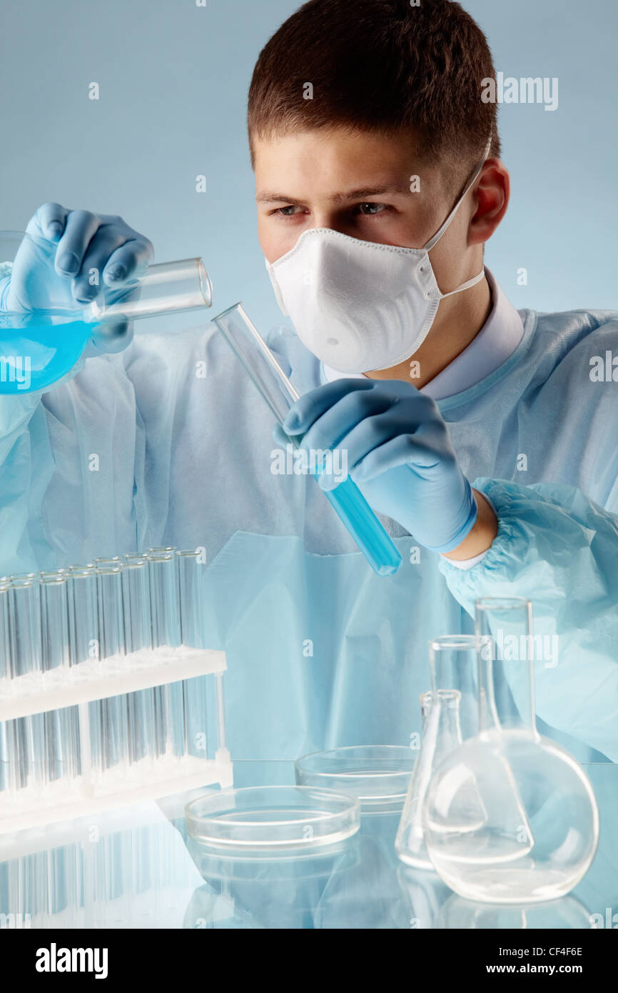 Male scientists mixing reagents in lab conditions Stock Photo - Alamy