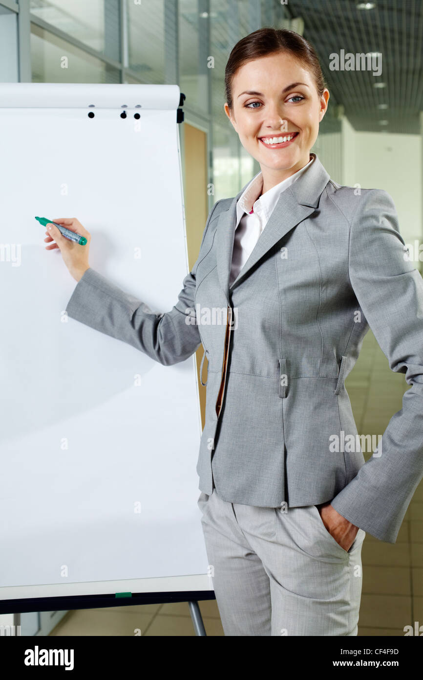 Confident young lady presenting a project to the business team Stock ...