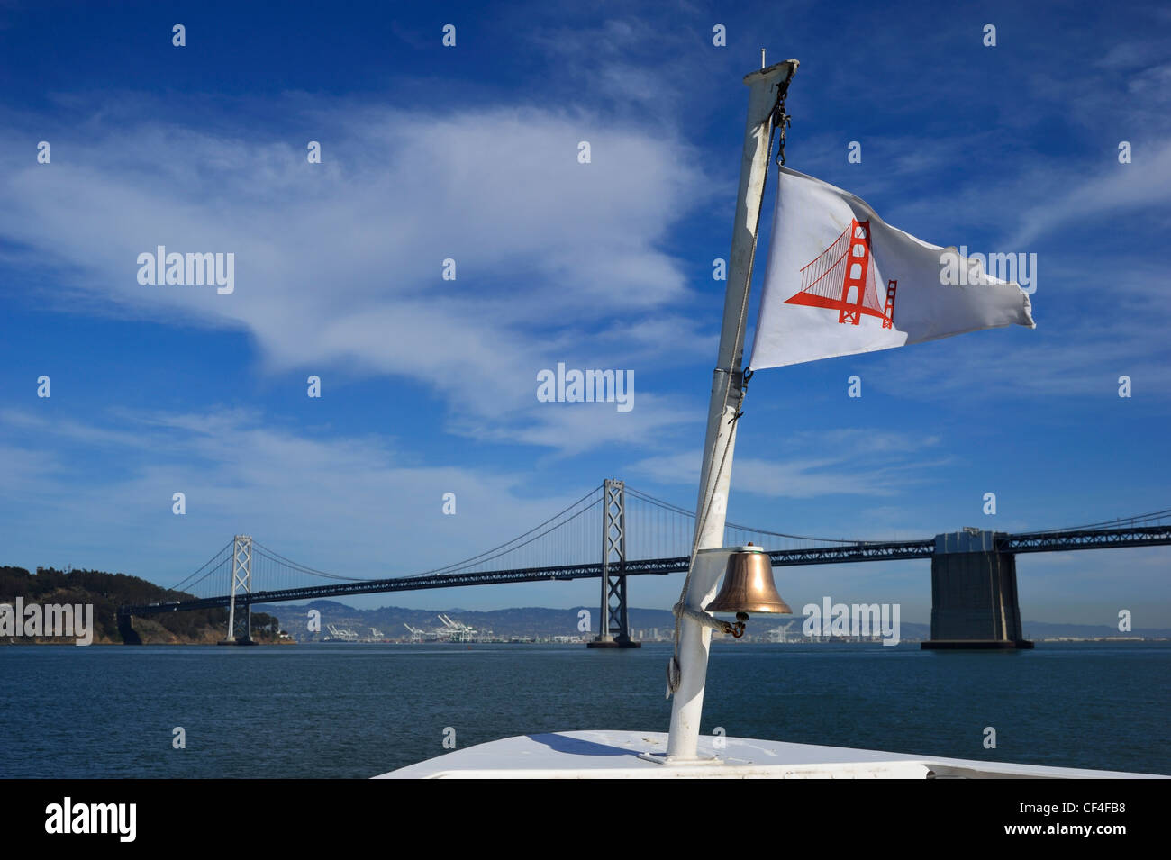 A Golden Gate Bridge flag in front of the Bay Bridge, San Francisco CA ...