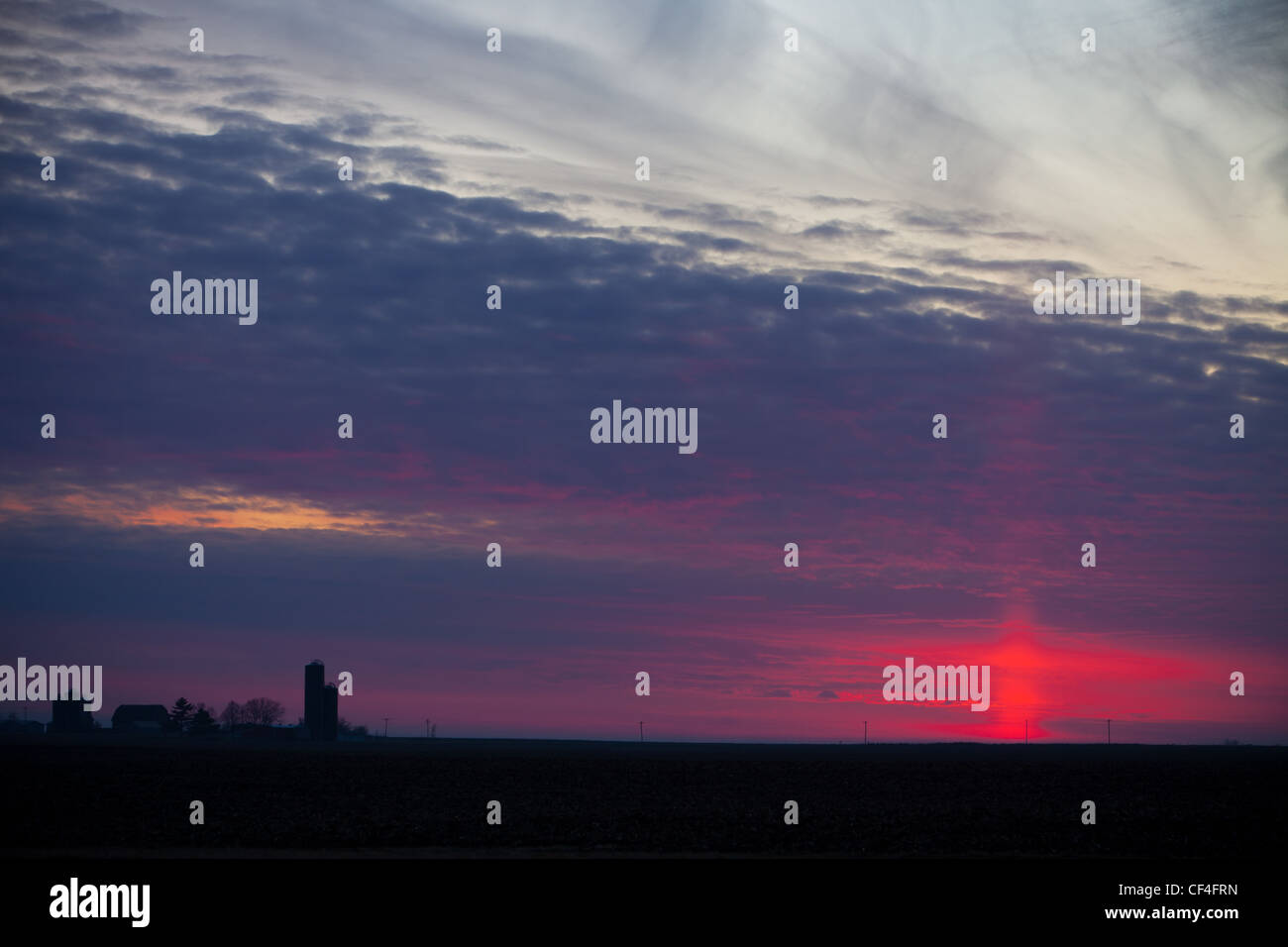 Just after sunset, a bright shaft of sunlight pierces the cloud cover ...