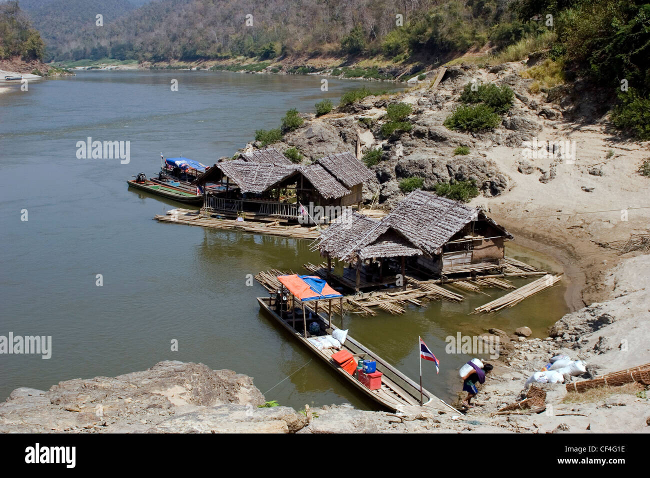 Longtail ferry boats are parked at on the Salawin River near the rural ...