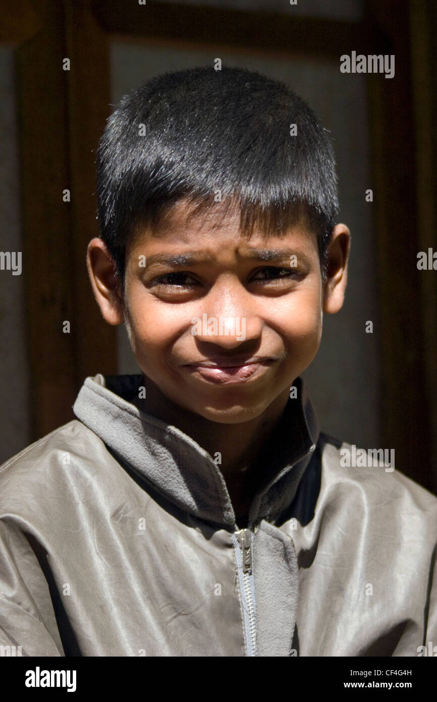 A young Muslim refugee boy is sitting in his home in the rural village ...
