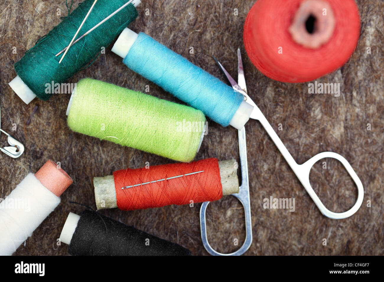 Sewing tools on a woolen fiber. Close-up color photo Stock Photo - Alamy