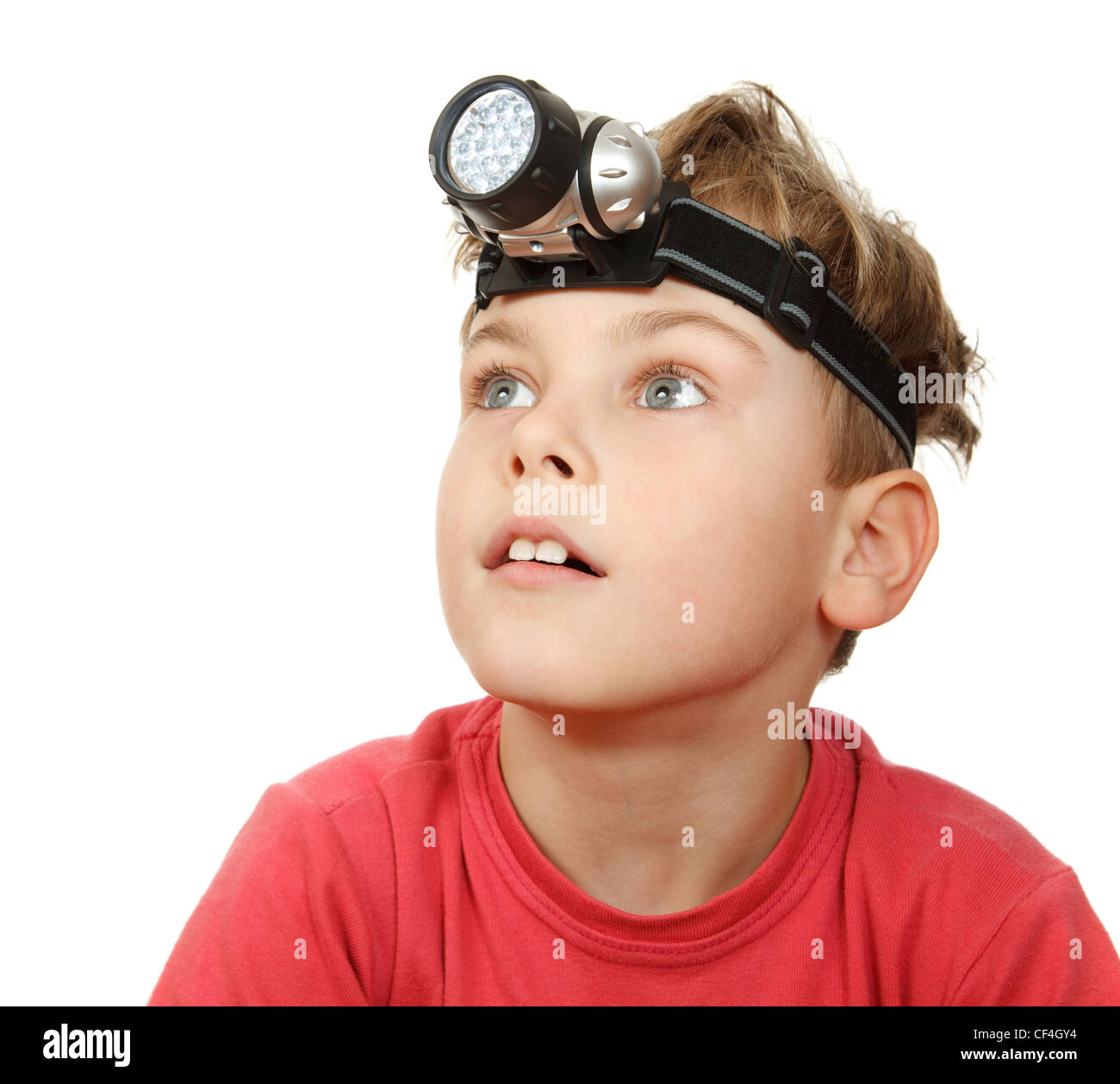 Portrait of boy with flashlight on his head on white background. Looks ...
