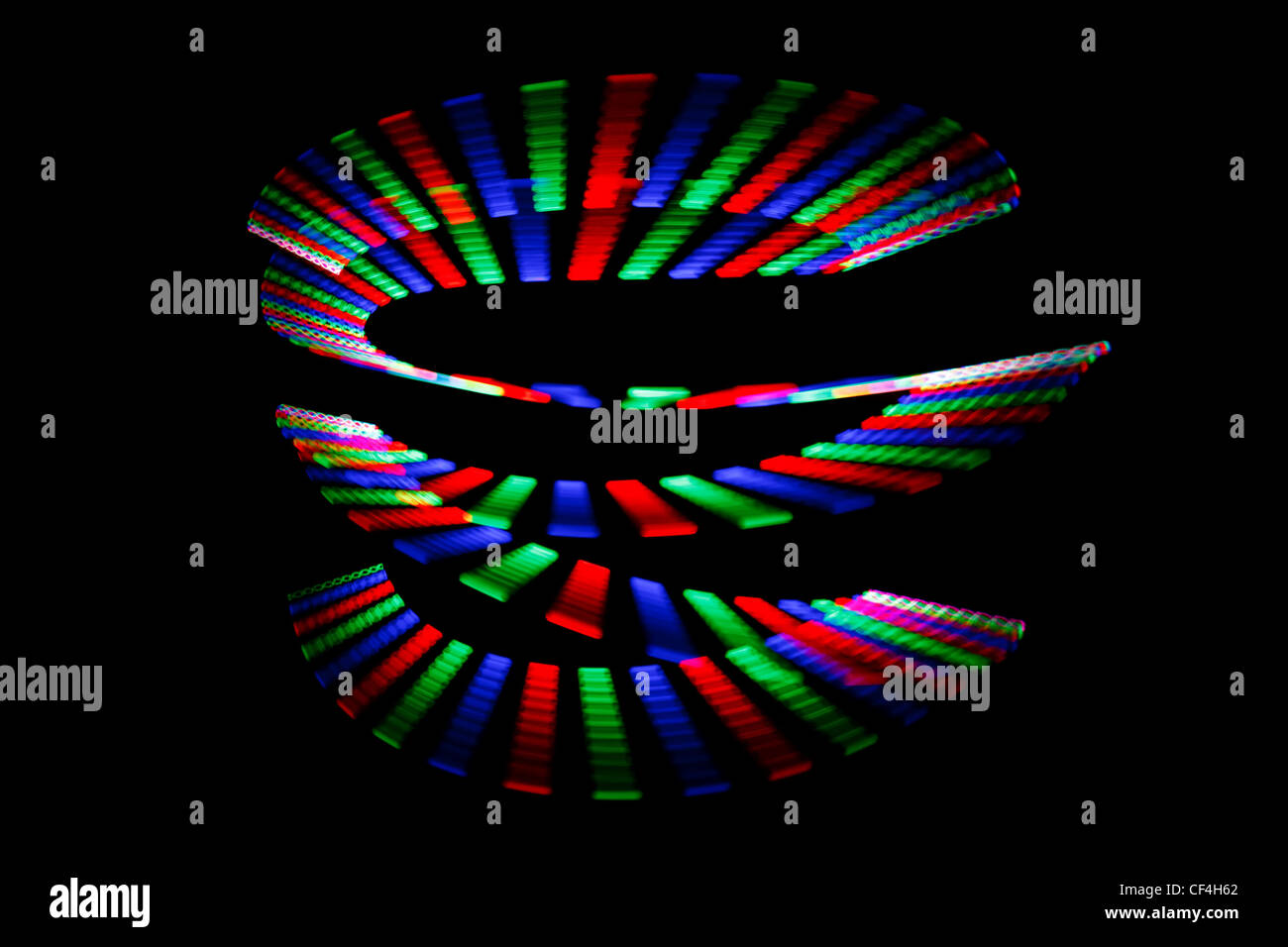 Luminous colors of rainbow trail in form of spiral on black background ...