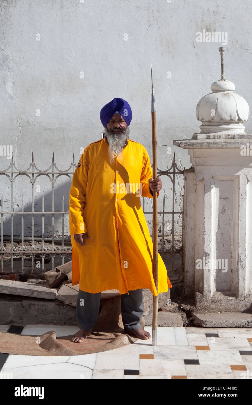 a traditionally dressed guard at the golden temple of Amritsar the ...