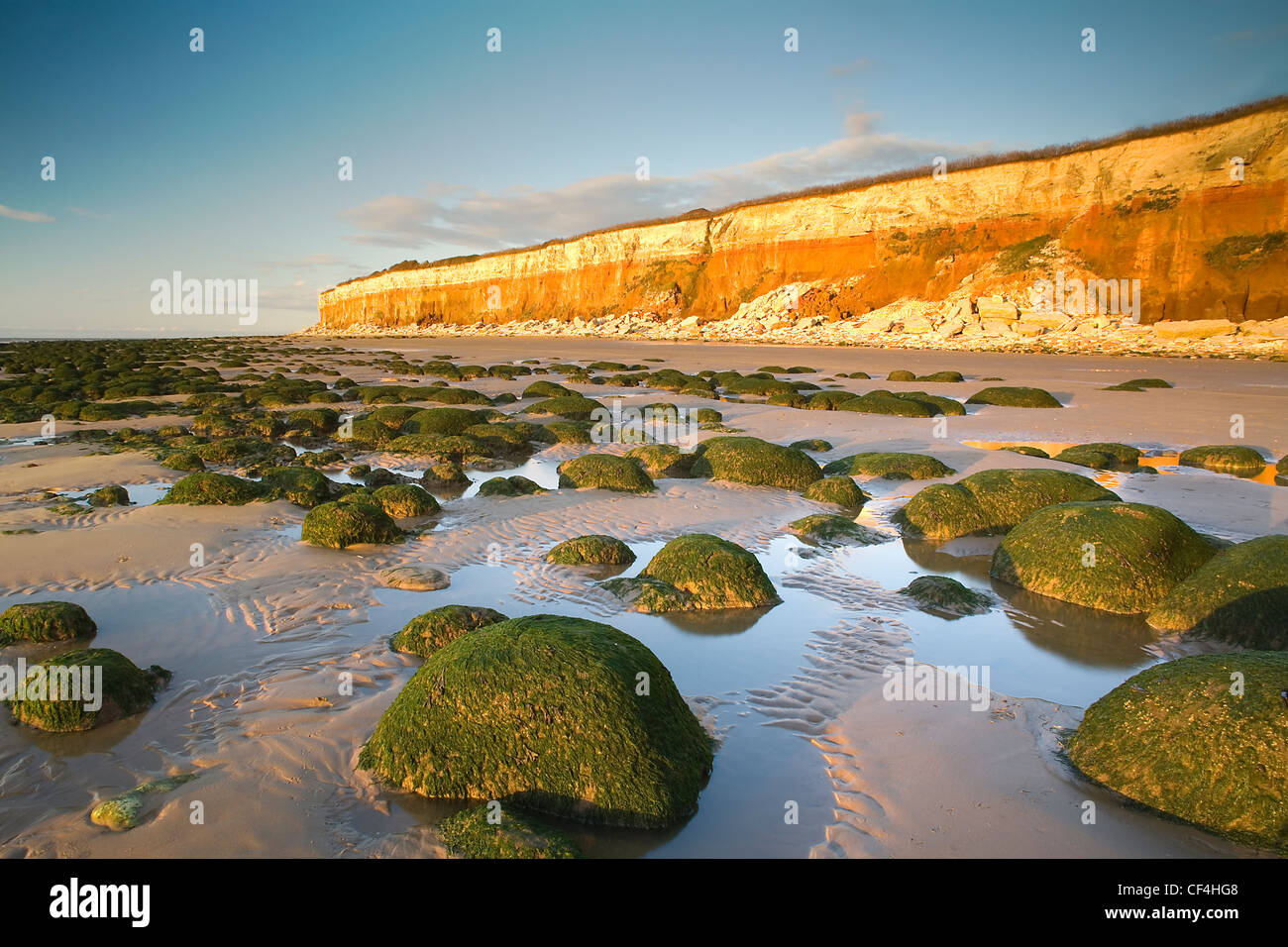 A view across rock pools to the cliffs beyond on Hunstanton beach Stock ...