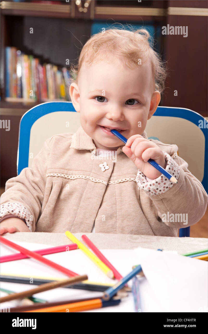 Little baby girl drawing with colorful pencils Stock Photo - Alamy