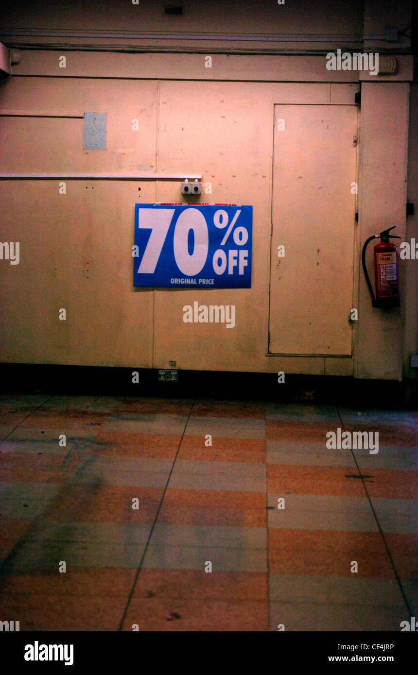 A 70% OFF sign pinned to a wall is all that remains inside a Woolworths ...