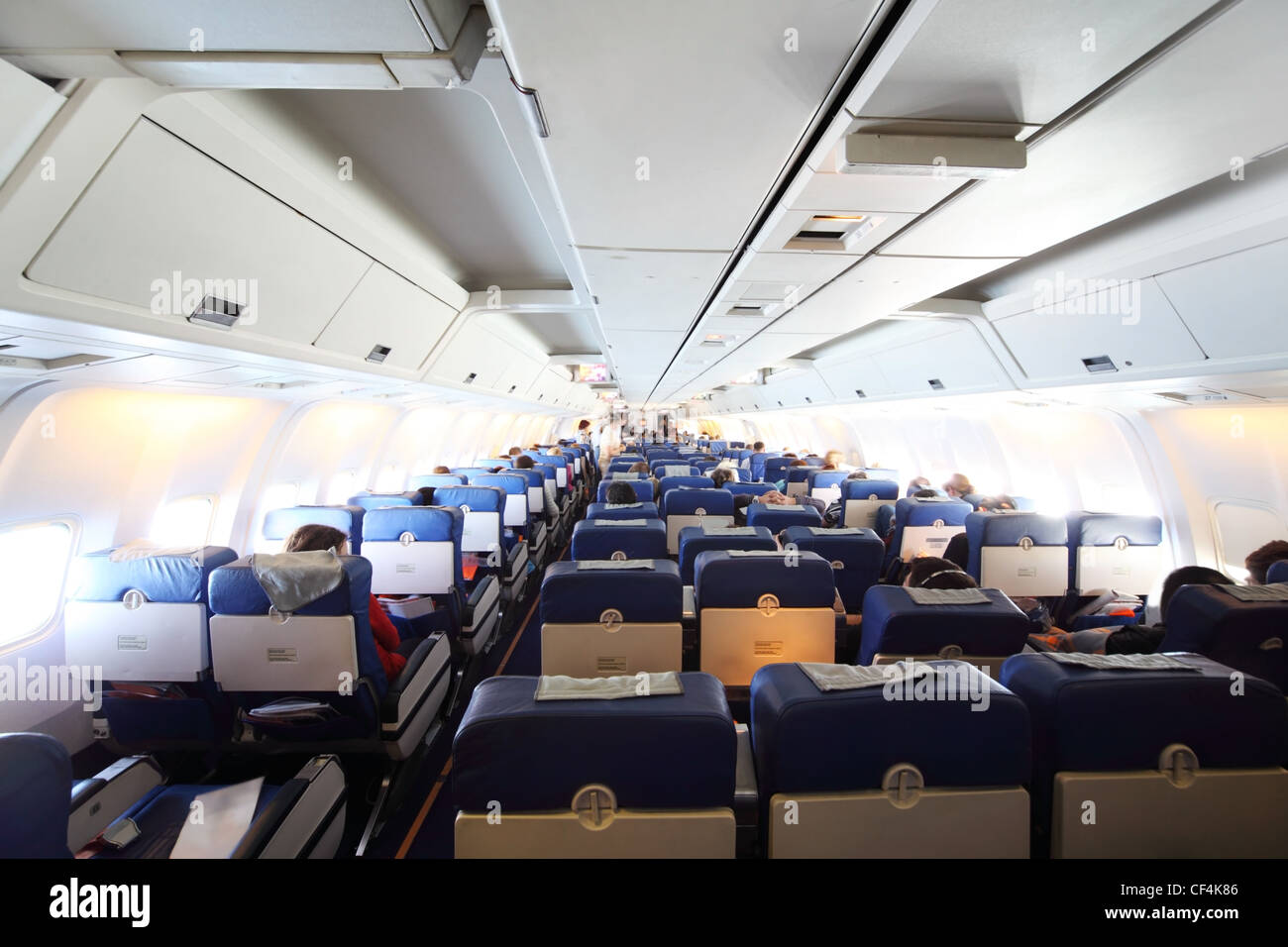 airplane cabin with passengers general view Stock Photo - Alamy