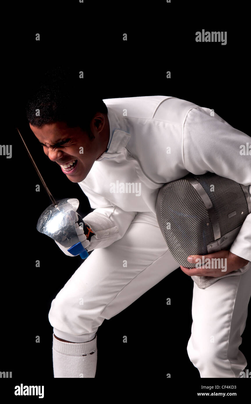 Male fencer isolated in a dark background Stock Photo - Alamy