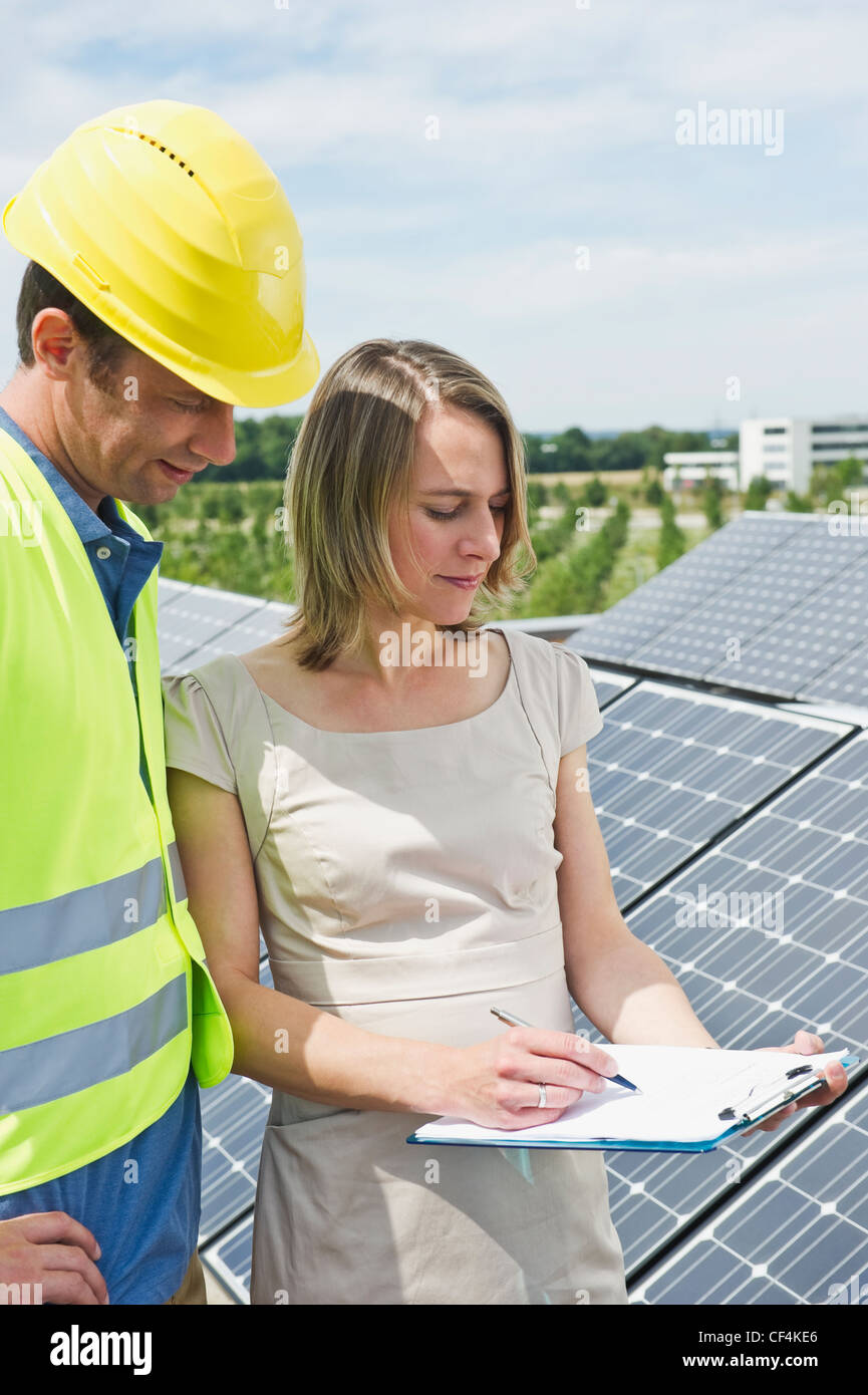 Germany, Munich, Engineers standing in solar plant Stock Photo - Alamy