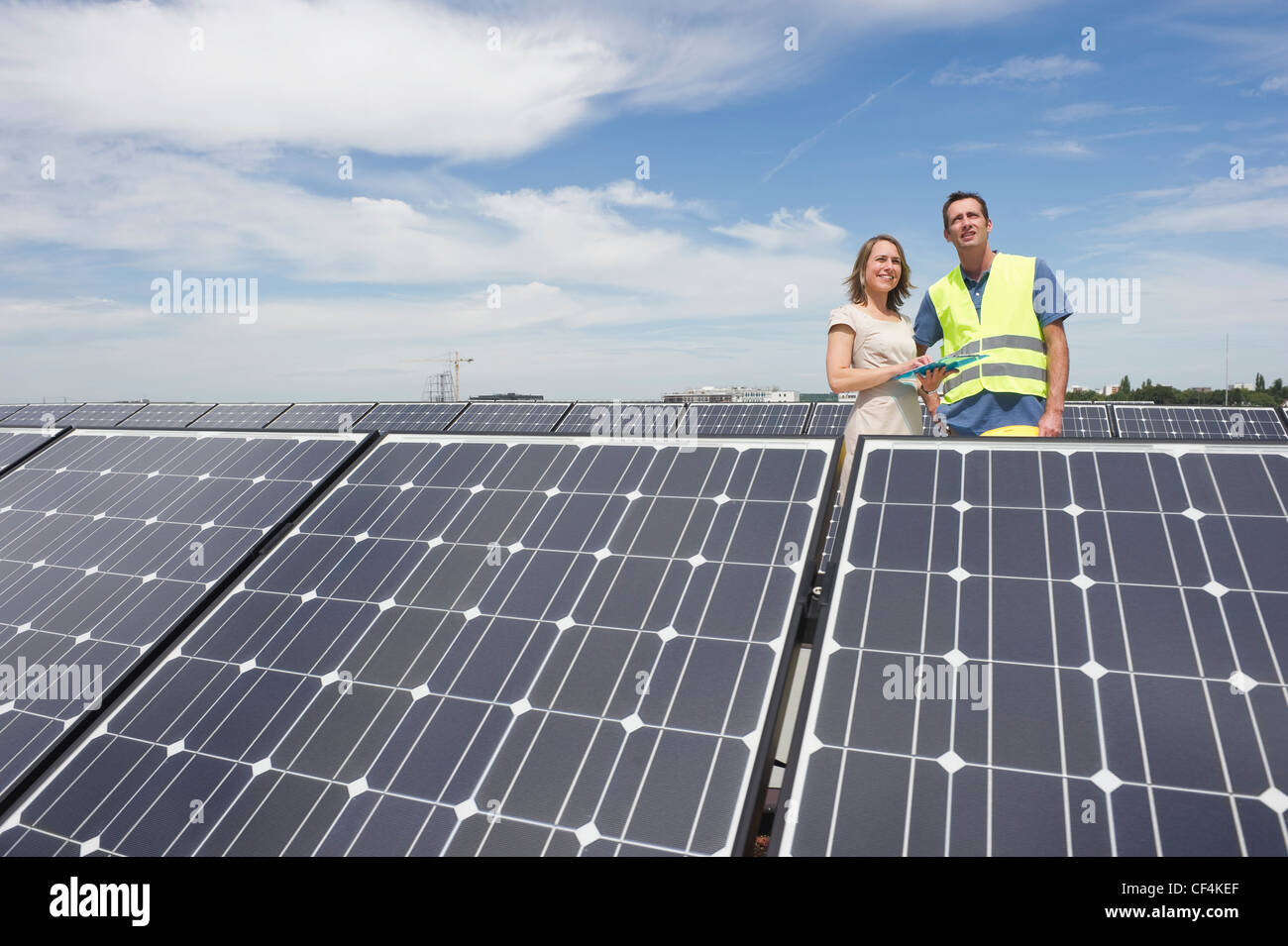 Germany, Munich, Engineers standing in solar plant, smiling Stock Photo ...