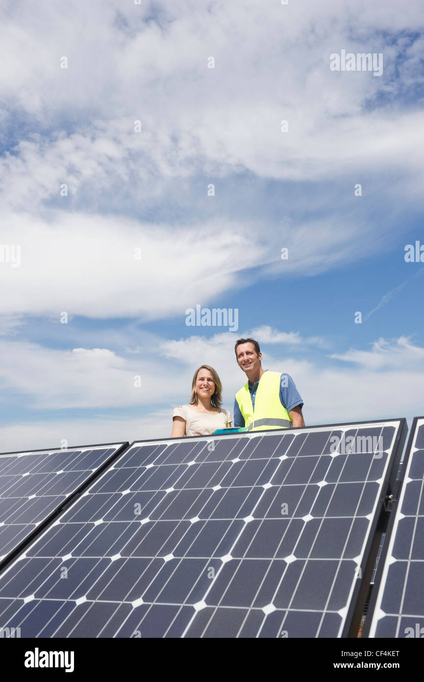Germany, Munich, Engineers standing in solar plant, smiling Stock Photo ...
