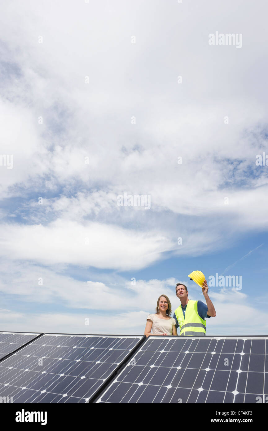 Germany, Munich, Engineers standing in solar plant, smiling Stock Photo ...