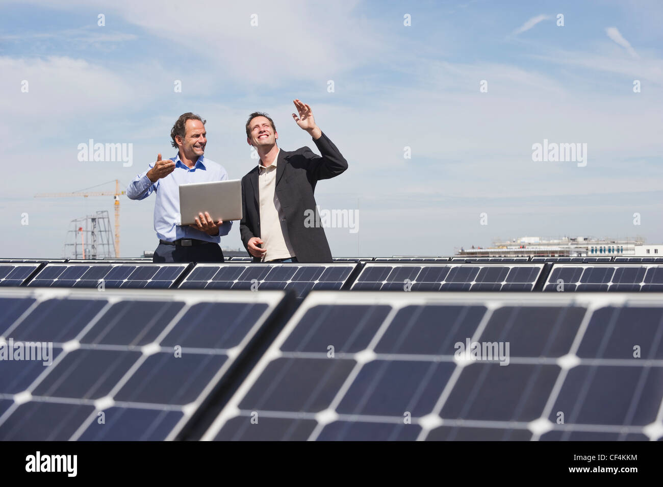 Germany, Munich, Engineer and man discussing in solar plant Stock Photo ...