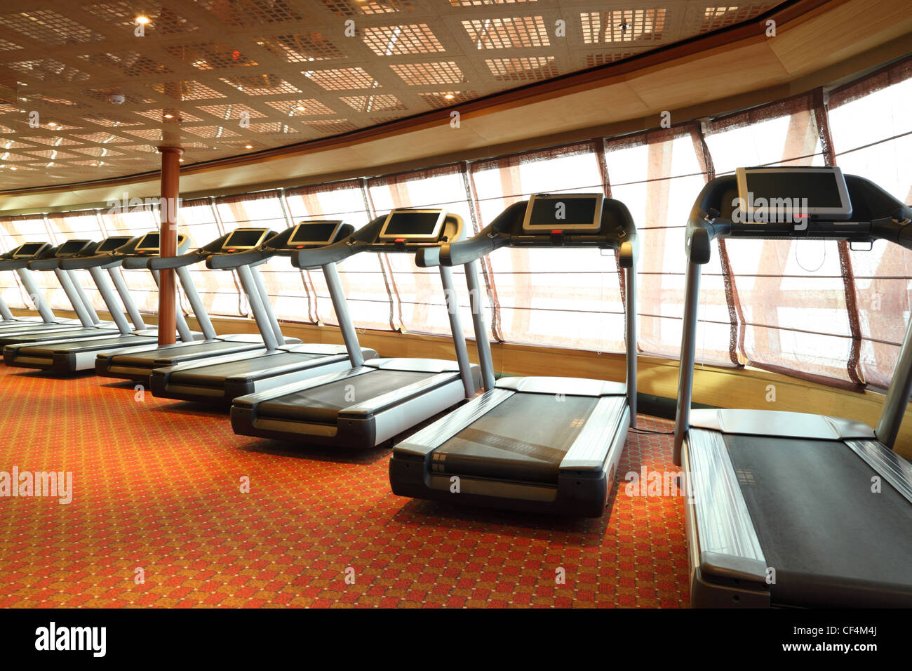 large gym hall with treadmills near windows in cruise ship Stock Photo ...