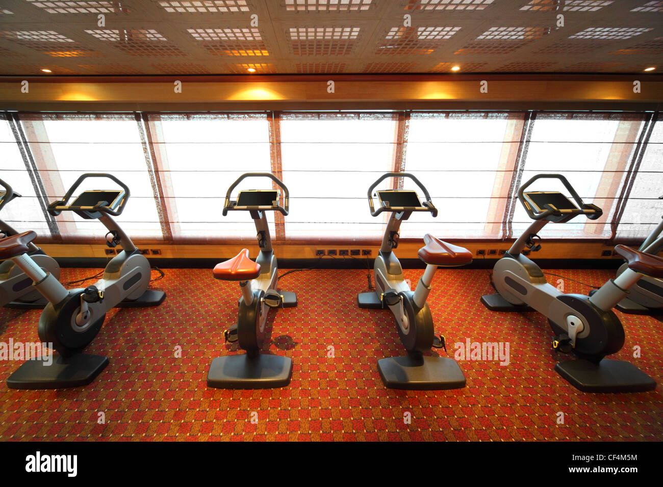 large gym hall with exercise bicycle near window in cruise ship view ...