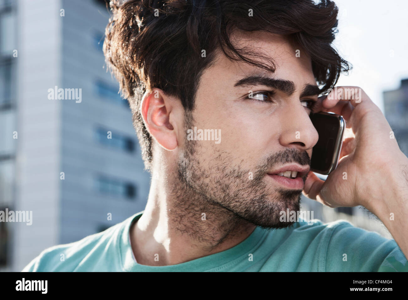 Germany, Cologne, Young man using cell phone, close up Stock Photo - Alamy