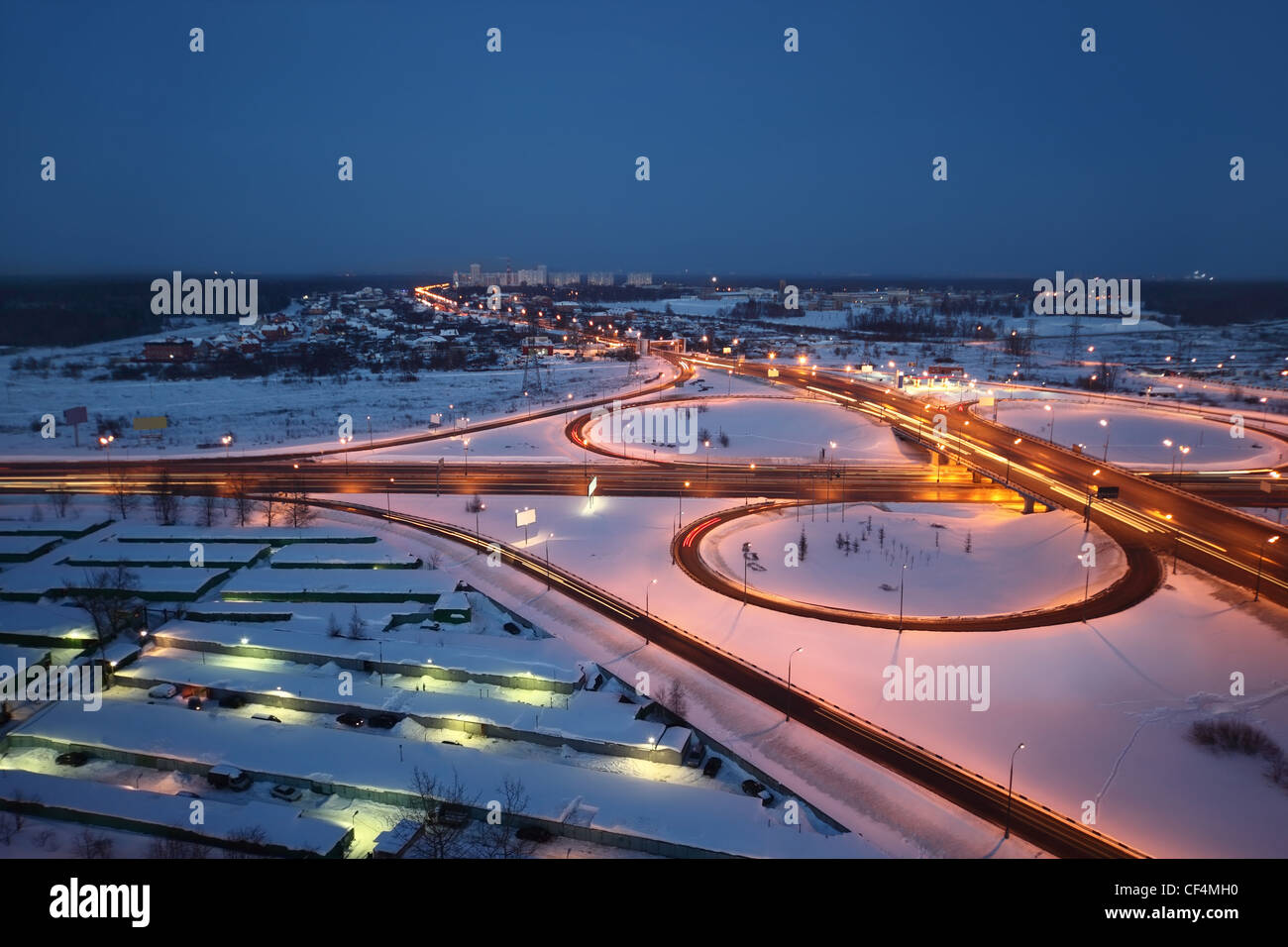 night winter cityscape with big interchange, lighting columns and ...