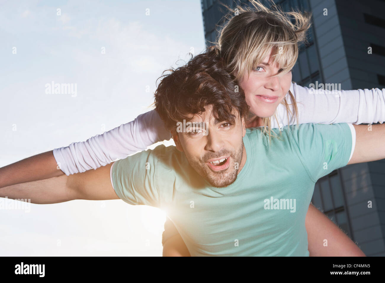 Germany, Cologne, Young couple flying, smiling, portrait Stock Photo ...