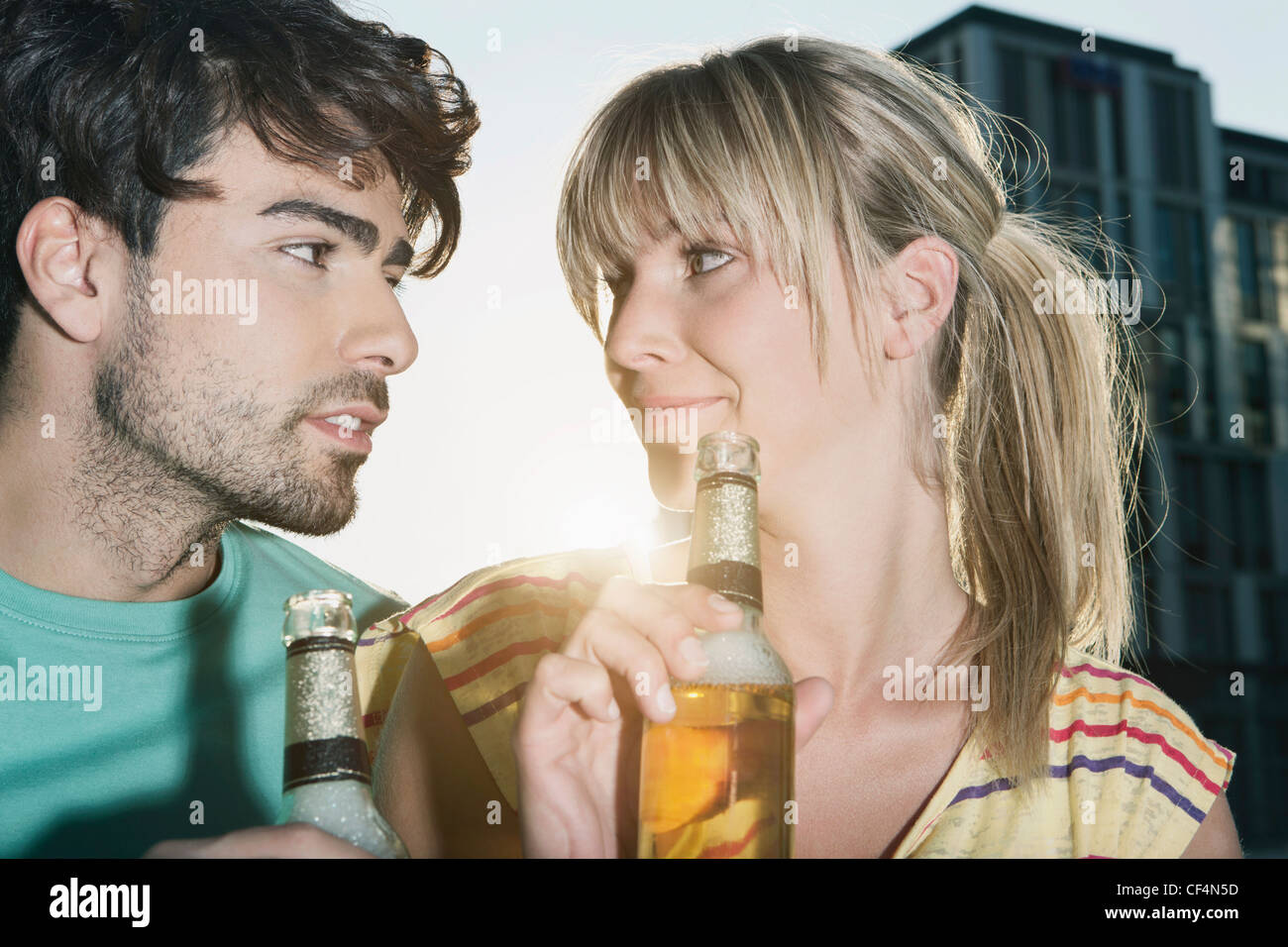 Germany, Cologne, Young couple drinking beer, smiling, close up Stock ...