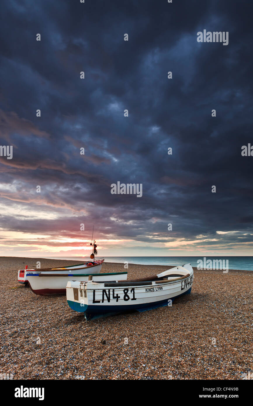 Three small fishing boats on the shingle beach of Cley next the Sea on ...