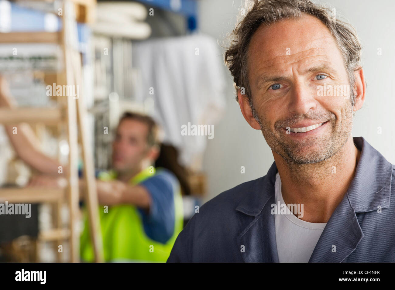 Germany, Bavaria, Munich, Manual workers working in warehouse Stock ...