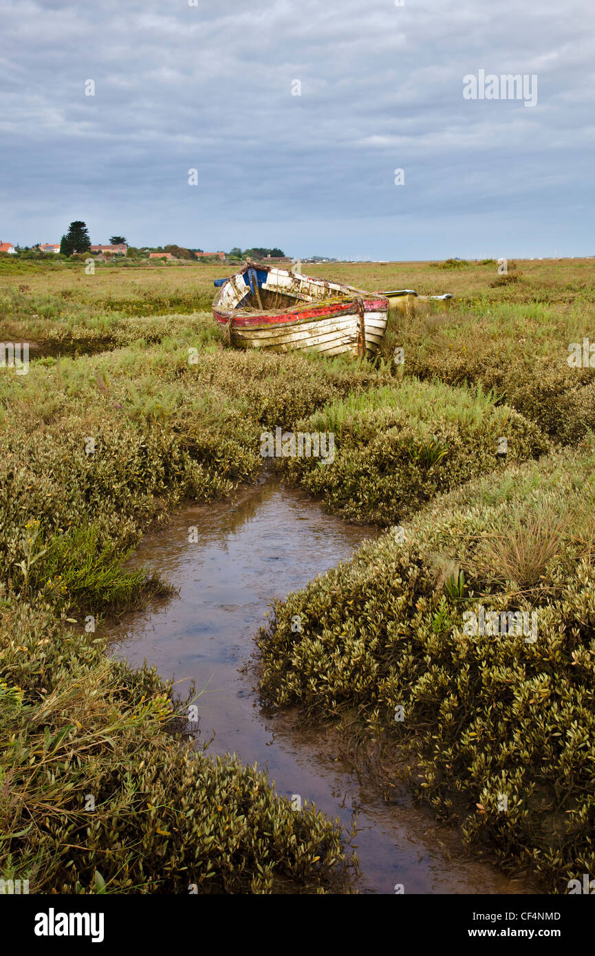 An old wooden fishing boat laying in the marshes at Burnham Deepdale on ...