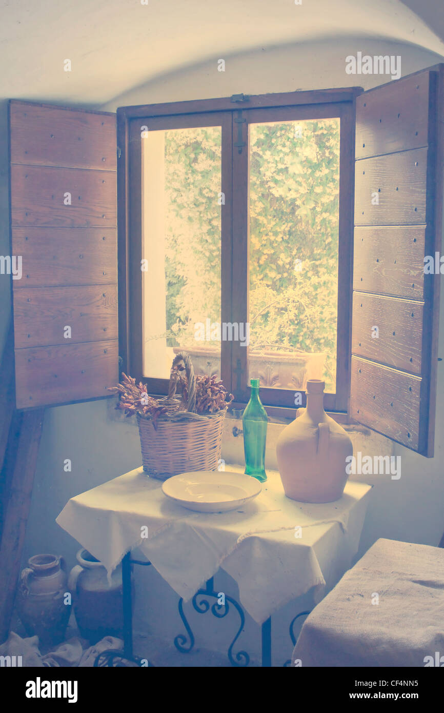 Shabby-chic table in front of a window Stock Photo - Alamy