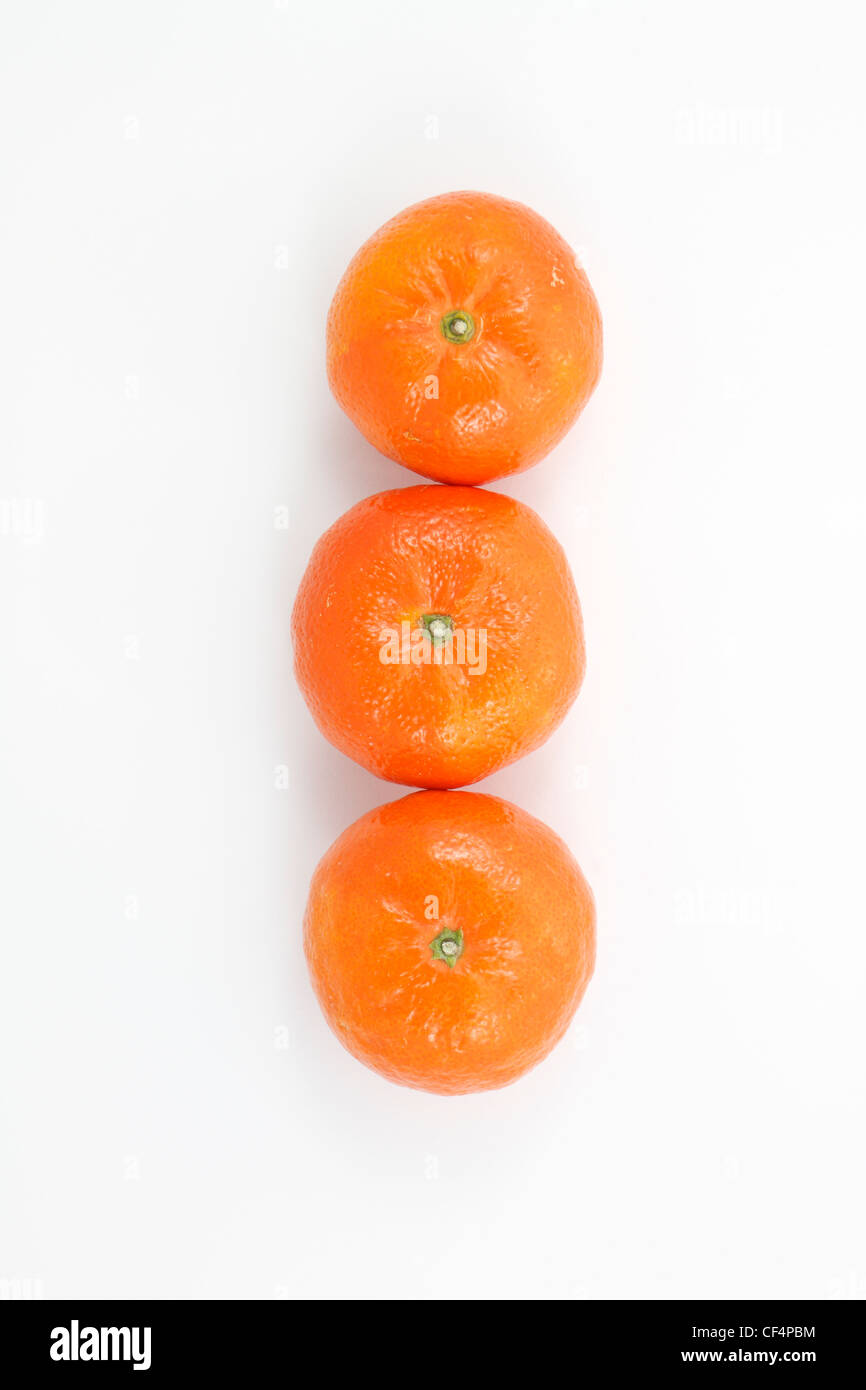 Three tangerines shot from above on white background Stock Photo - Alamy