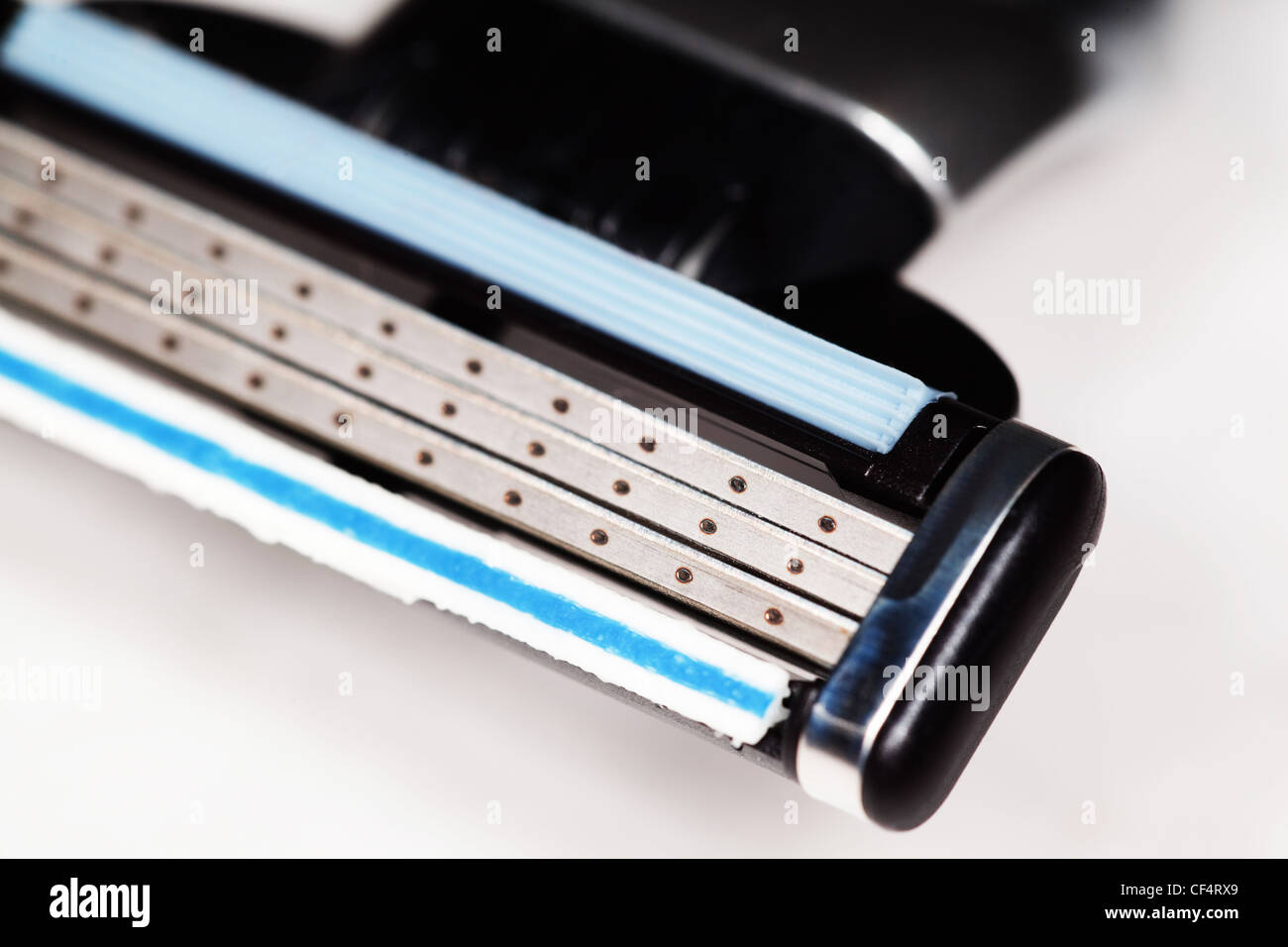 dark razor with three blades and additional devices, white background ...