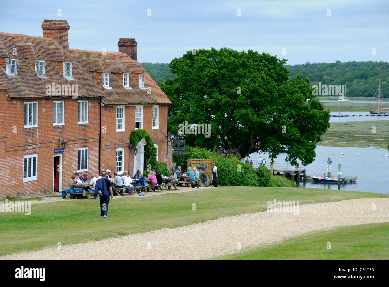 People sitting outside the Master Builder's pub in Buckler's Hard, a ...