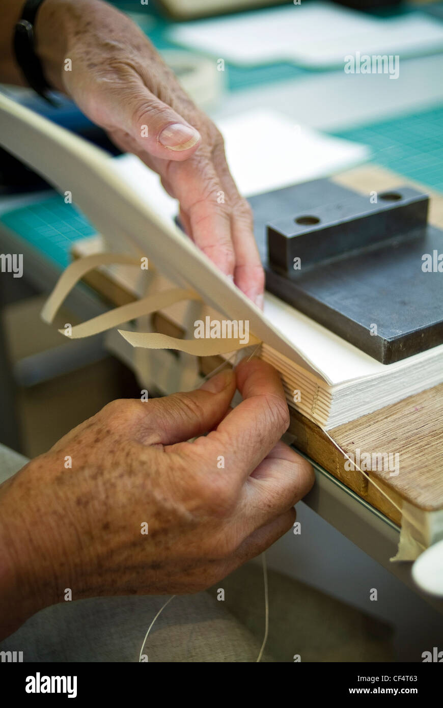 Sewing together the cover of a hand made book Stock Photo - Alamy