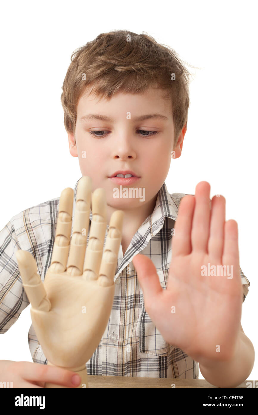 boy is played by wooden hand of manikin isolated on white background ...