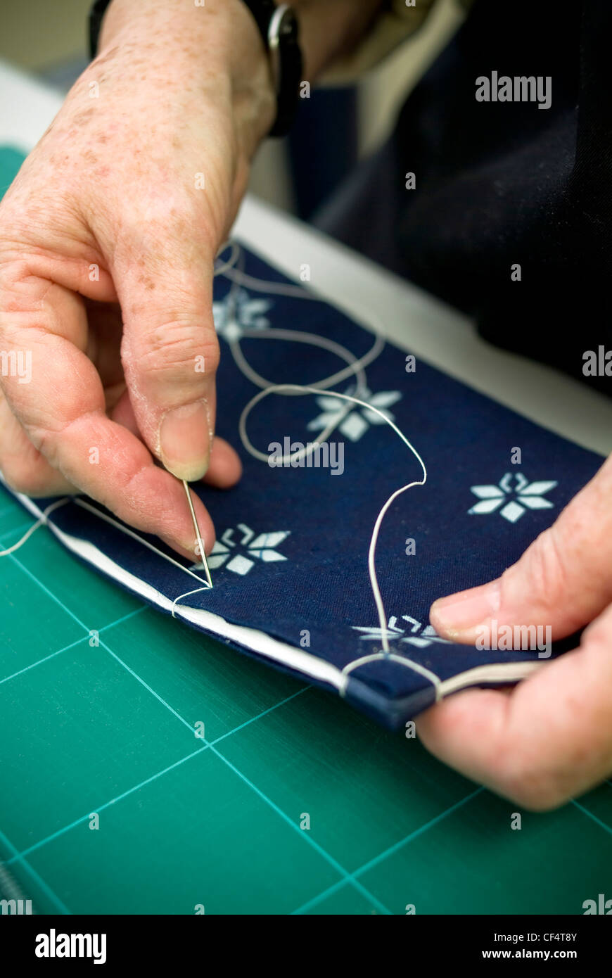 Sewing together the cover of a hand made book Stock Photo - Alamy