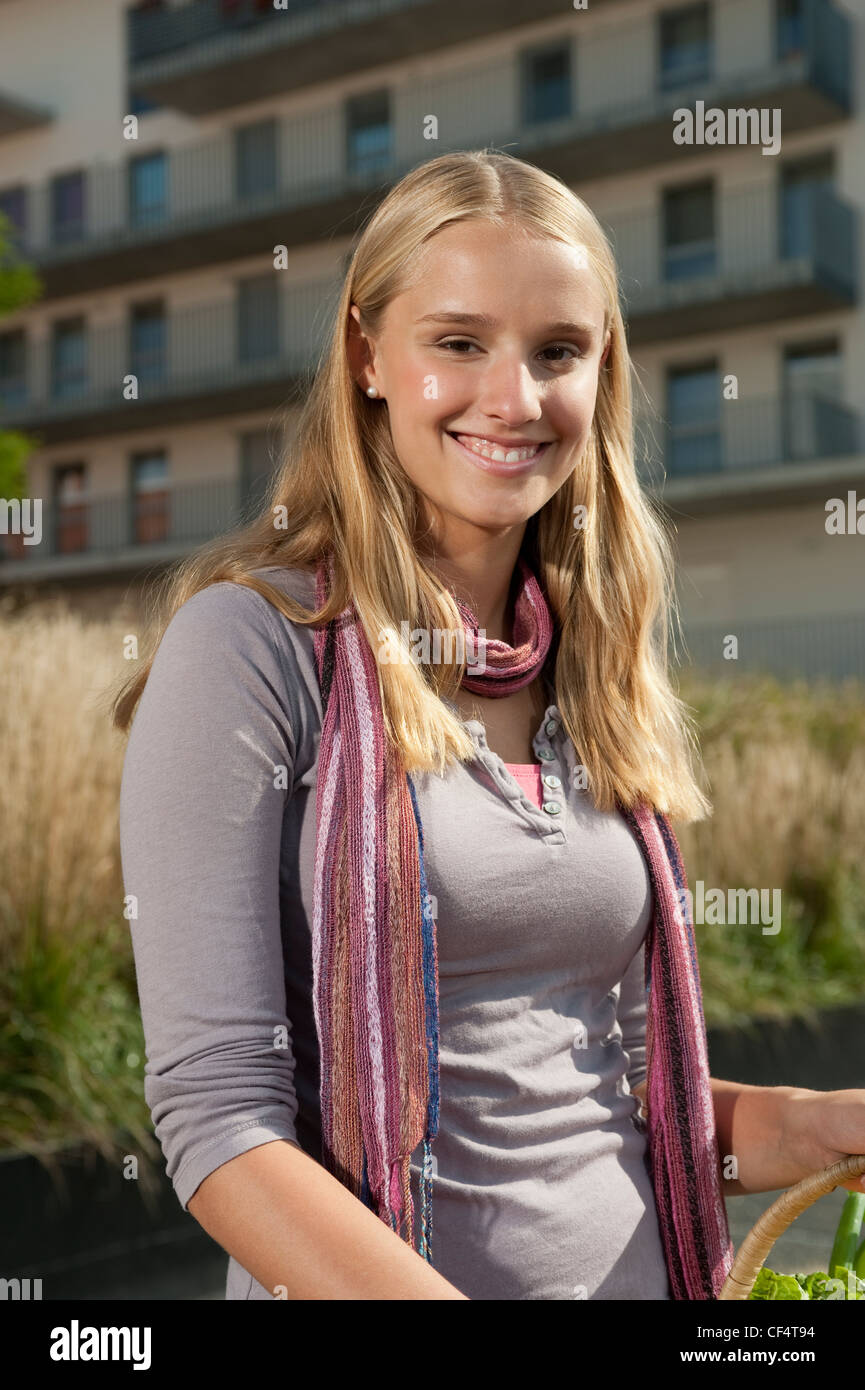 Germany, Bavaria, Teenage girl with basket, smiling, portrait Stock ...