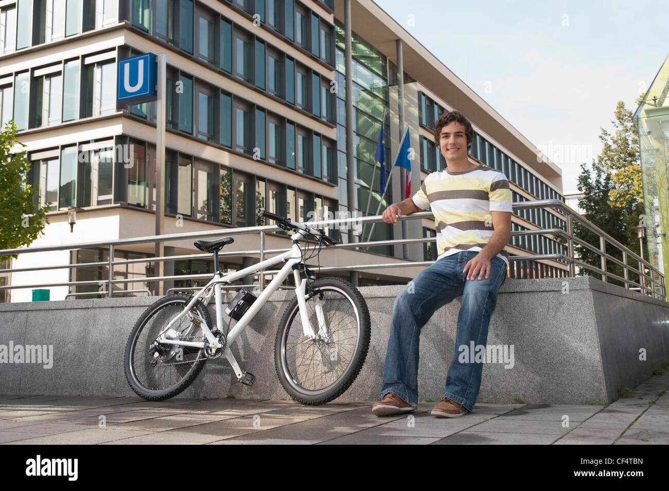Germany, Bavaria, Young man with bicycle, smiling, portrait Stock Photo ...