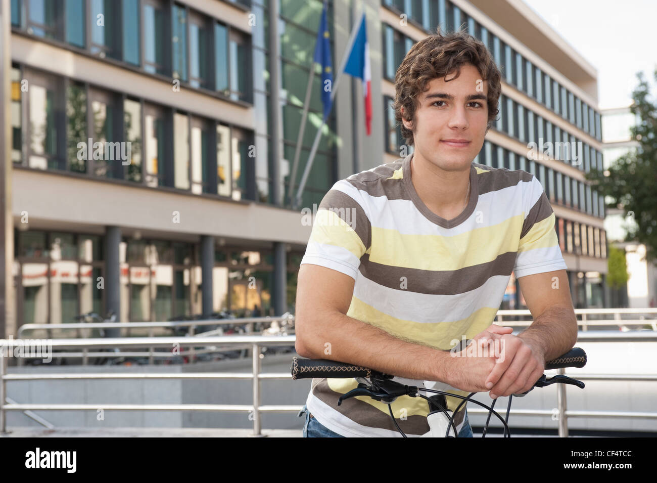 Germany, Bavaria, Young man on bicycle, smiling, portrait Stock Photo ...