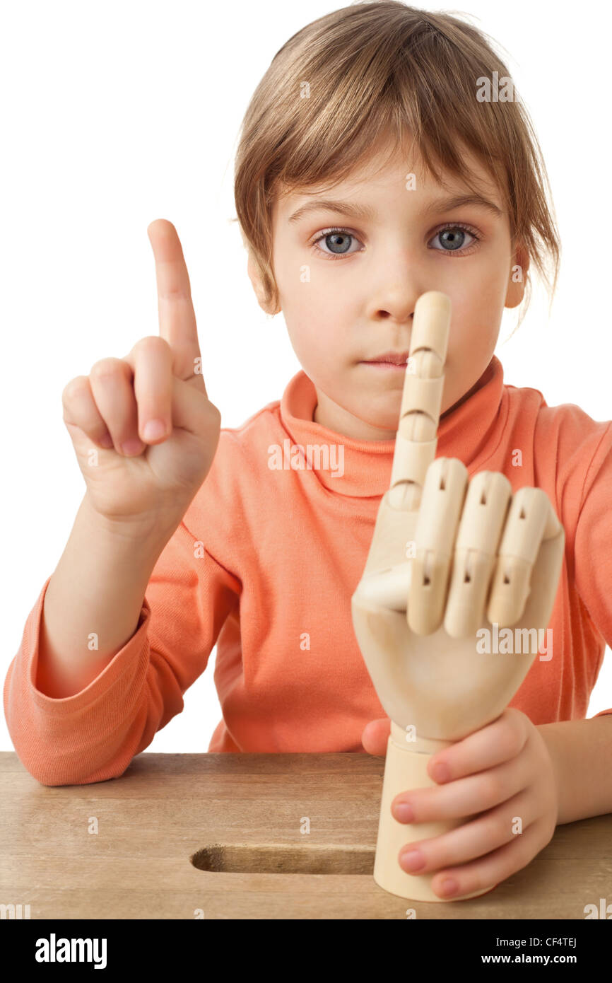 pretty little girl is played by wooden hand of manikin isolated on ...