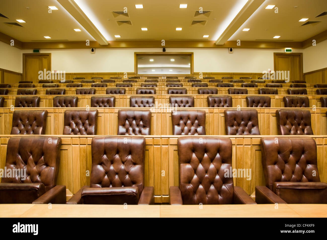 Conference halls with magnificent leather armchairs and wooden tables ...